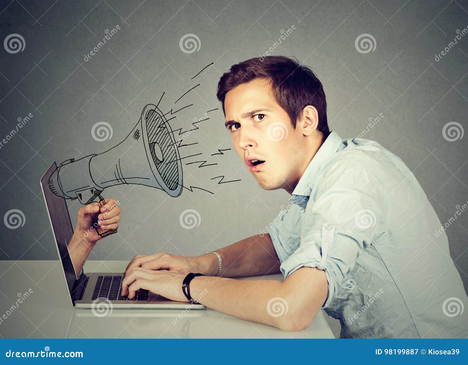 Anxious Man Sitting at Table Using Working on a Computer with Megaphone ...