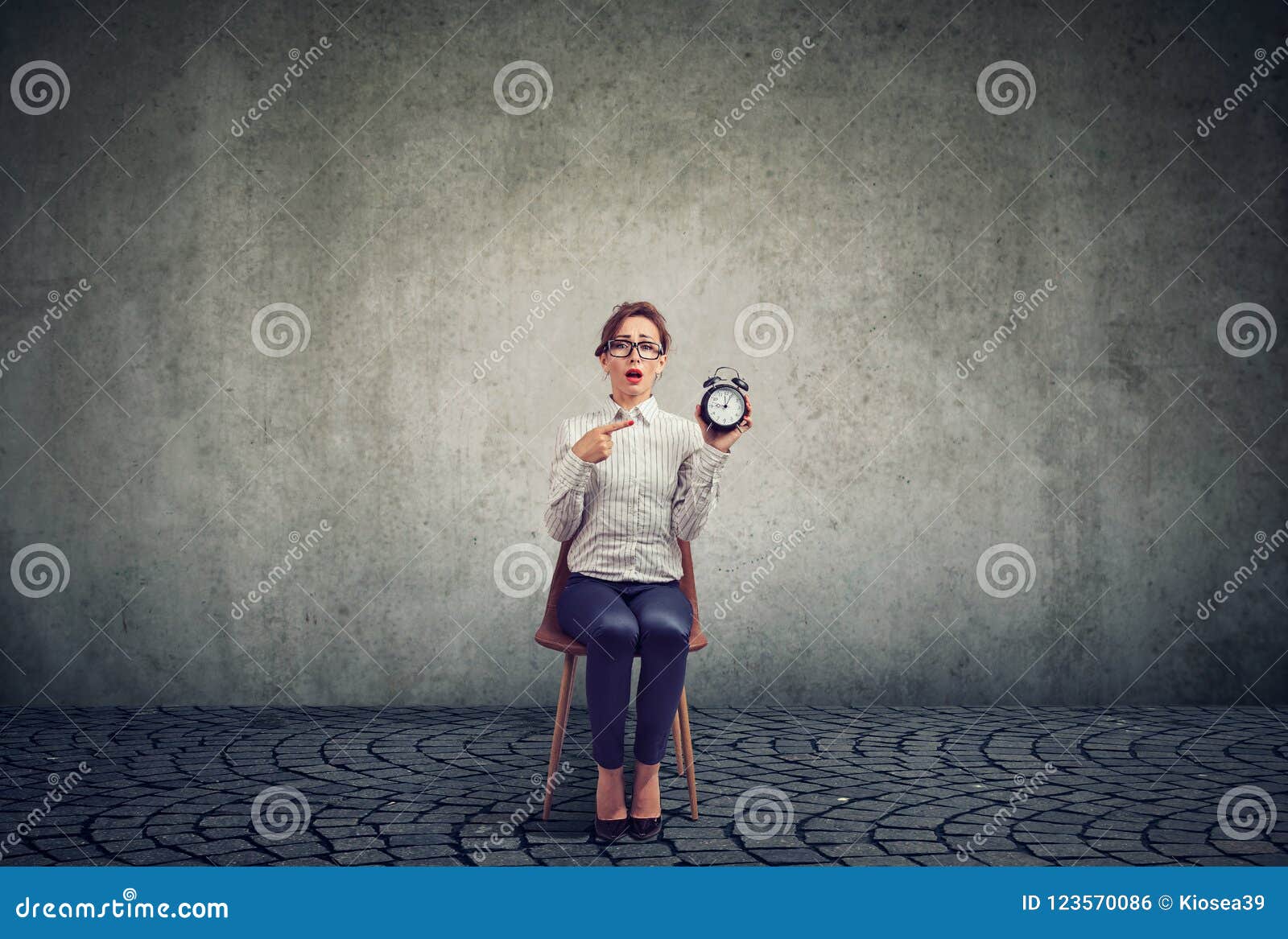 Anxious Woman with Alarm Clock Waiting for an Interview Stock Photo ...