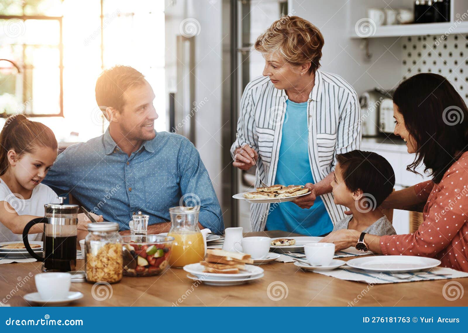 Anyone for Second Helpings. a Multi Generational Family Enjoying Breakfast Together at Home ...
