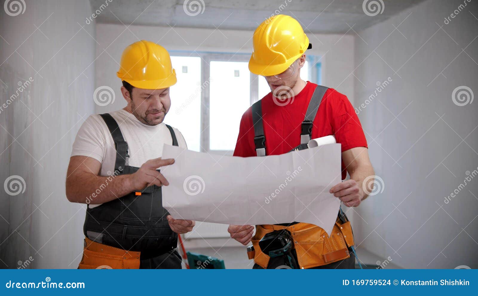 Apartment Repair - Two Men Workers Discussing Layout Stock Photo ...