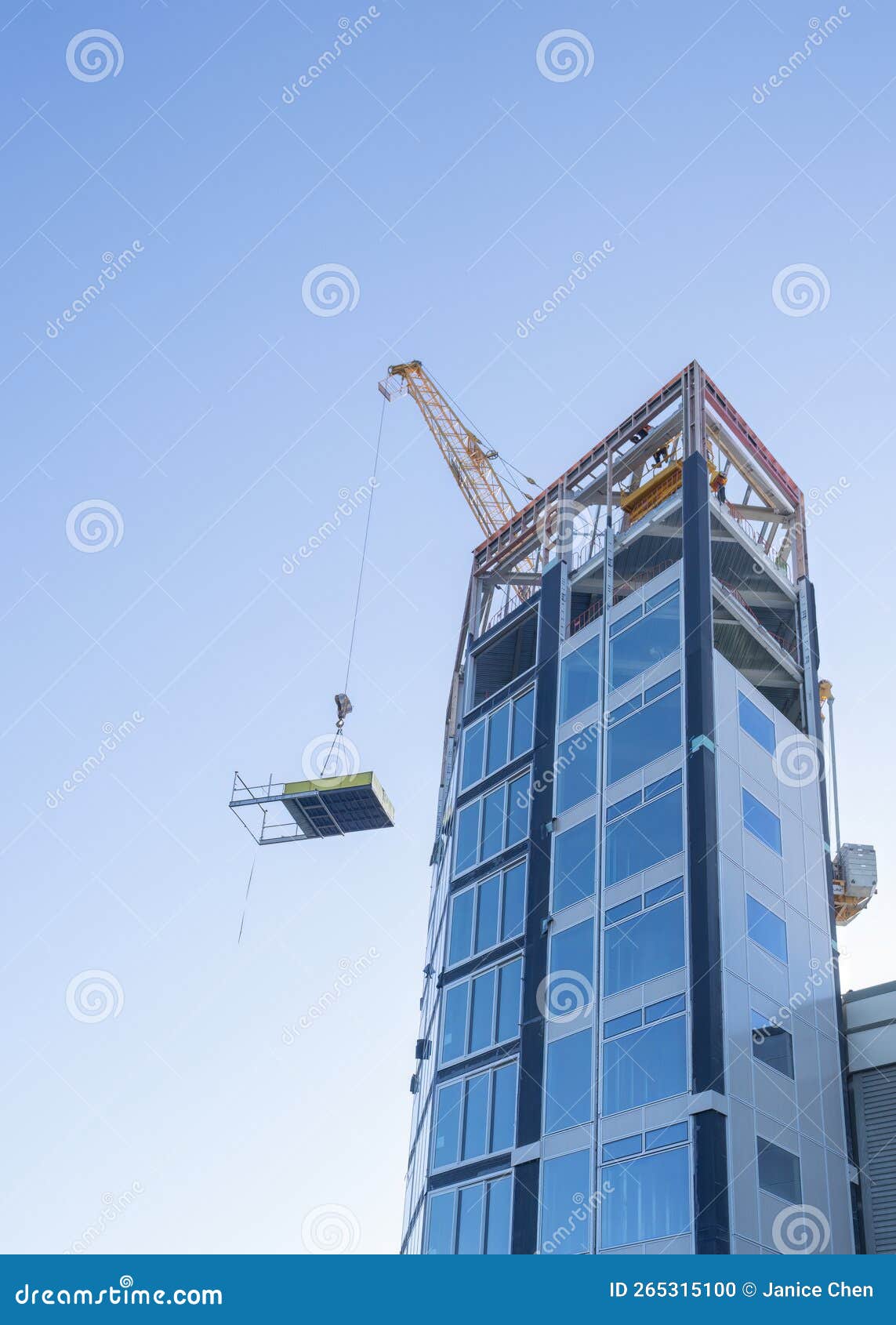 Apartment Under Construction. Crane Lifting Building Materials Up ...