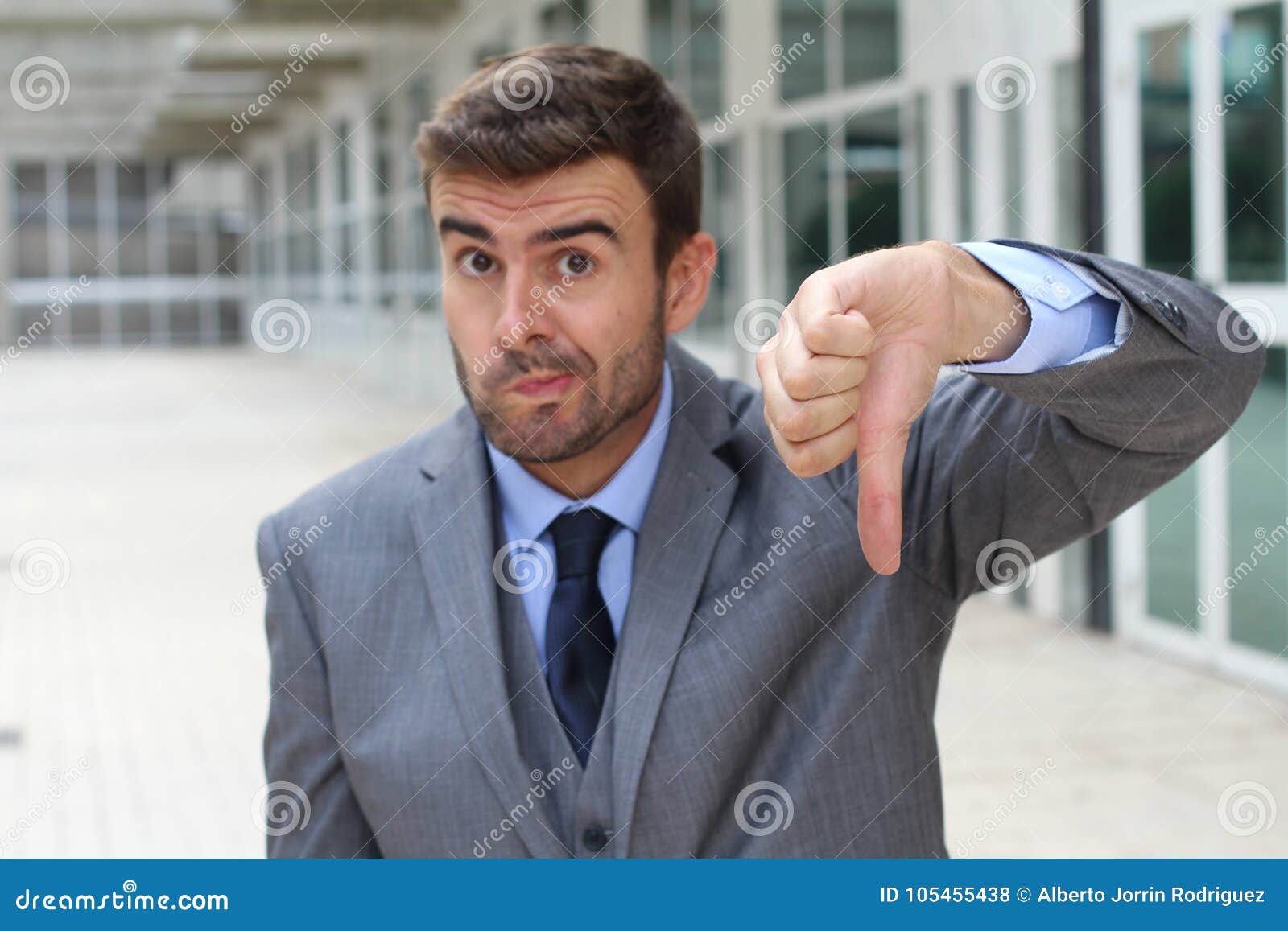 Apologetic Businessman Giving a Thumbs Down Stock Photo - Image of ...