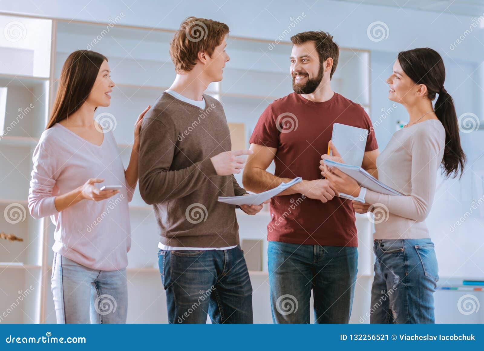 Appealing Four Colleagues Debating Over Presentation Stock Image ...