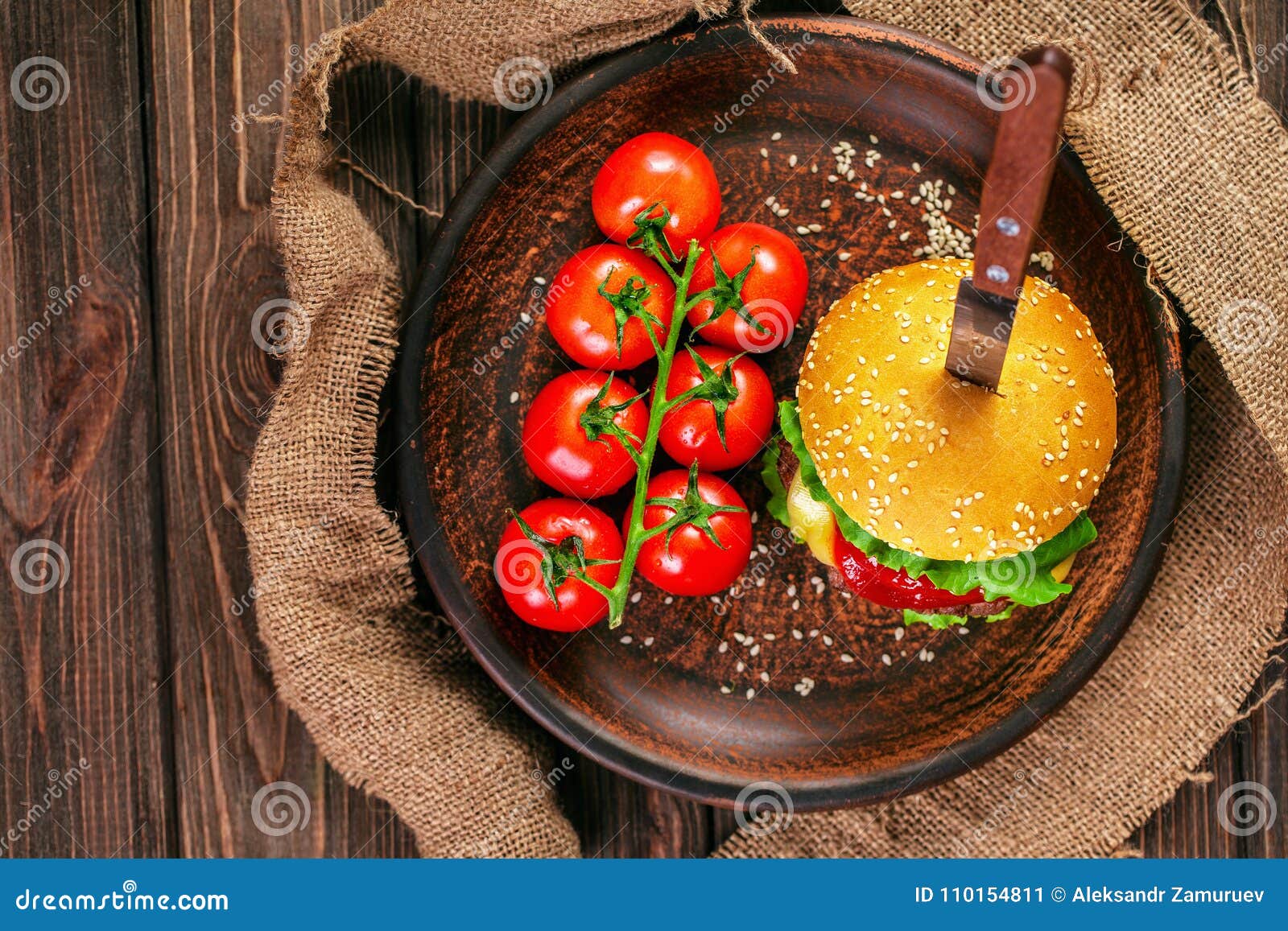 Appetizing Burger with Tomatoes on Table Stock Image - Image of ...
