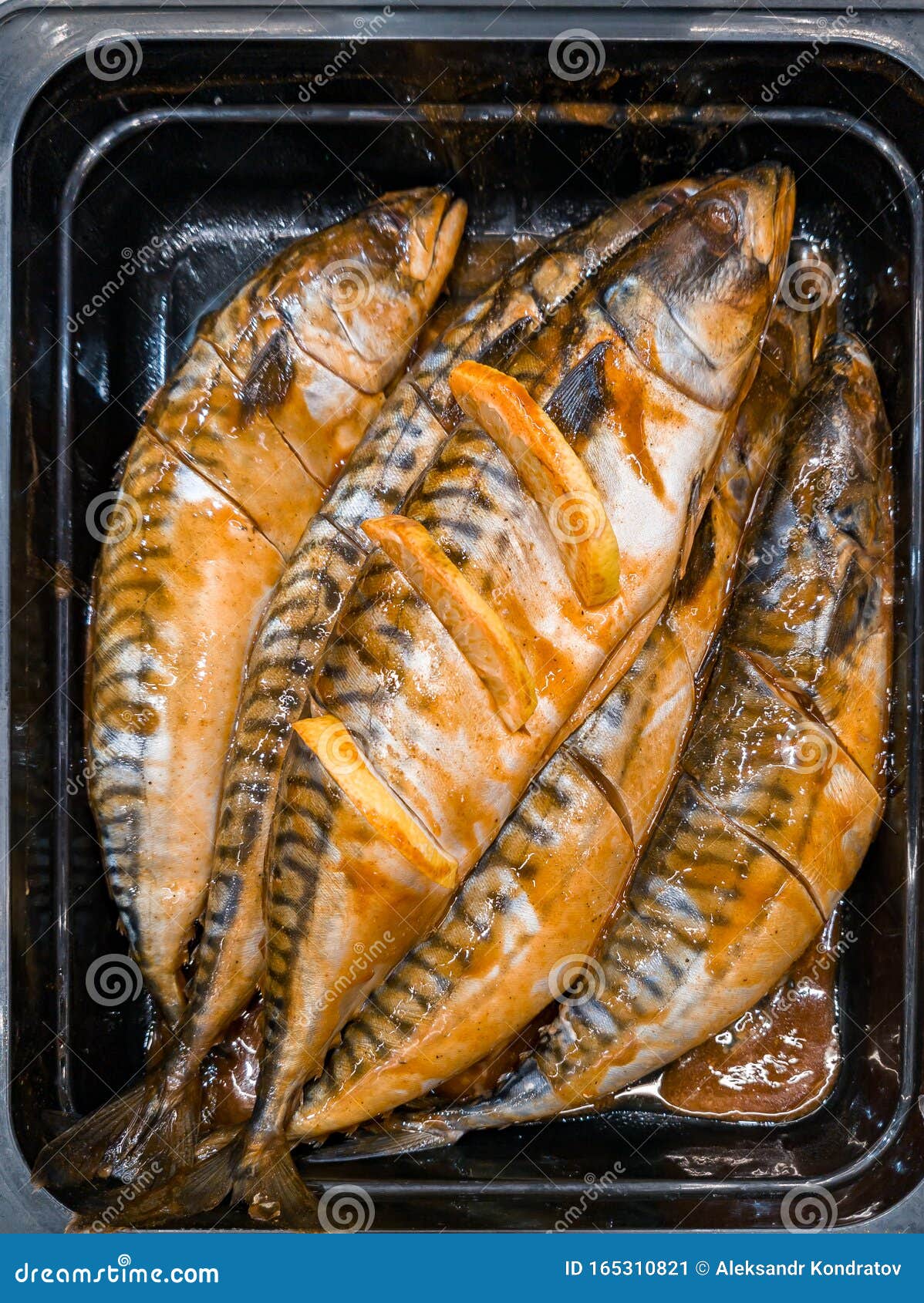 An Dish of Sea Fish with Cuts into Which a Lemon is Inserted in a Food ...