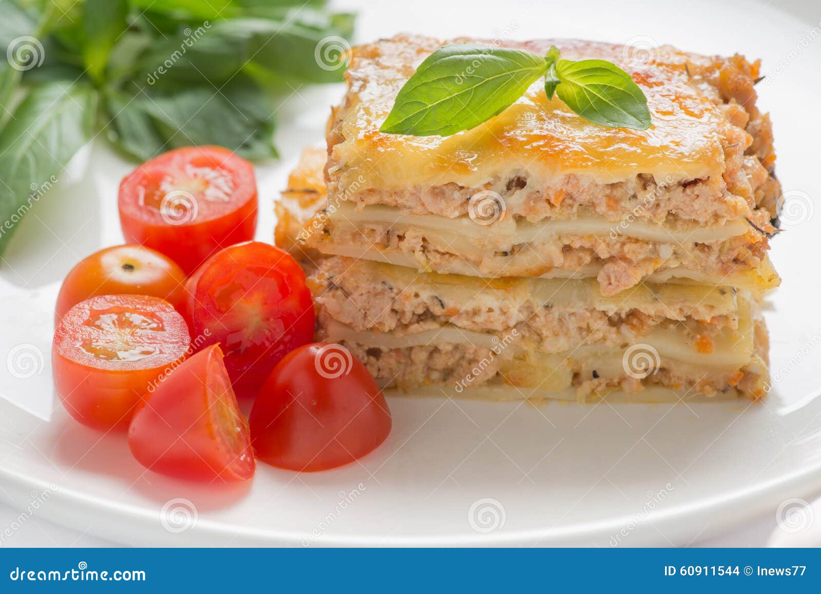 Appetizing Lasagna Piece with Basil on White Plate Stock Photo - Image ...