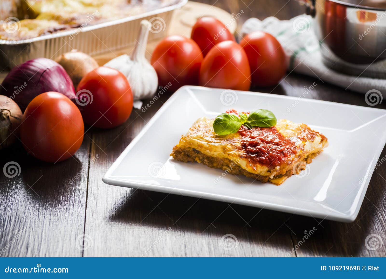 Appetizing Portion of Lasagna on a White Plate with Tomato Sauce Stock ...