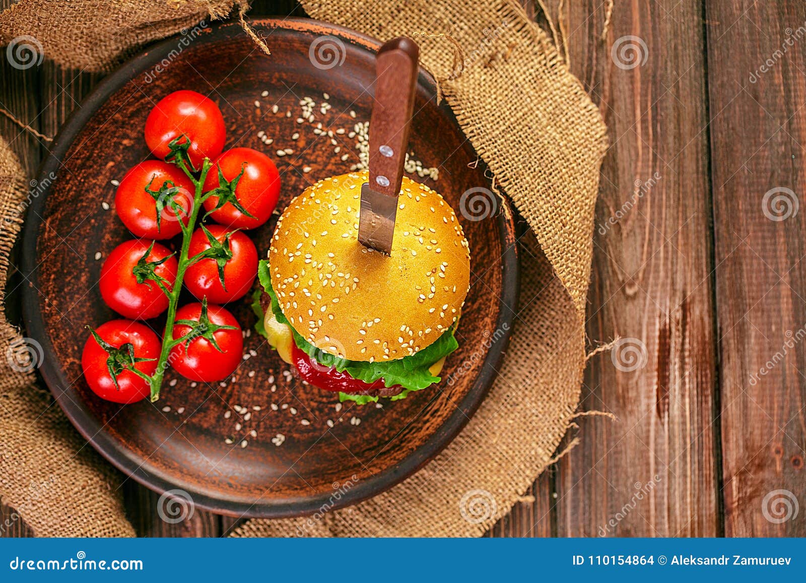 Appetizing Burger with Tomatoes on Table Stock Photo - Image of onion ...