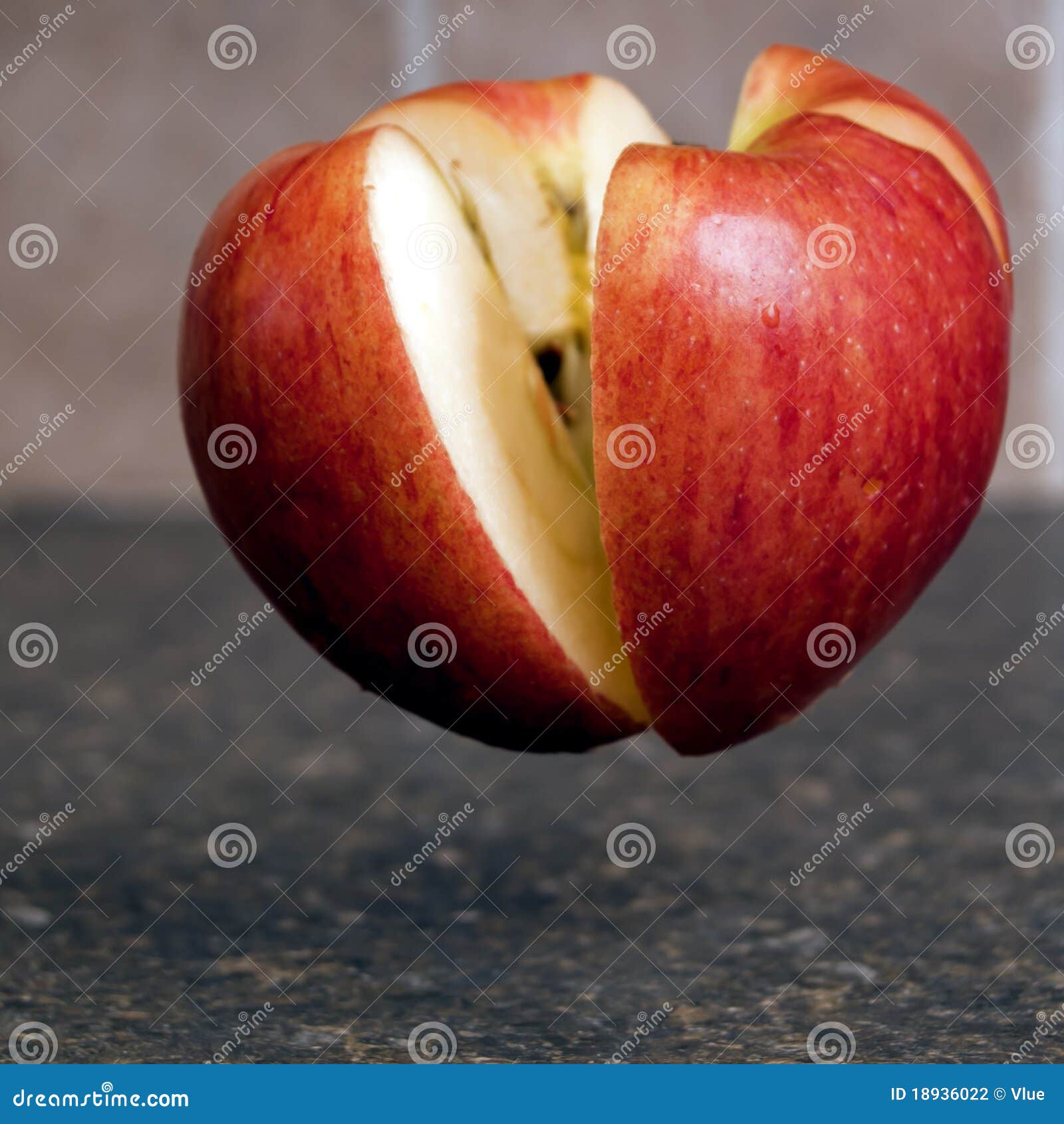 Apple Being Cut in Half stock photo. Image of apple, kitchen - 18936022