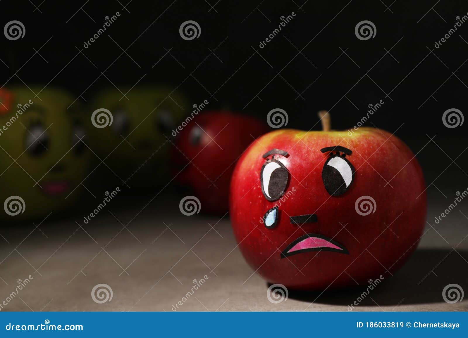 Apple with Crying Face on Grey Table. Concept of Jealousy Stock Image ...