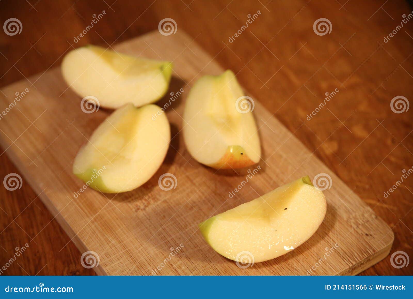 Apple Cut into Four Pieces on a Wooden Cutting Board Stock Photo ...