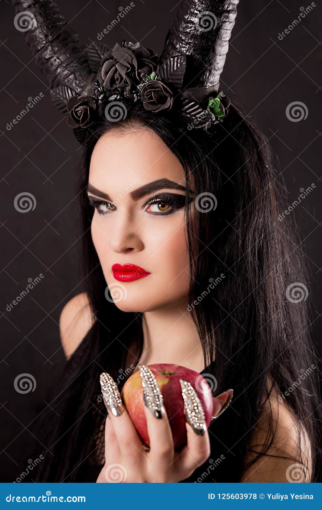 An Apple in the Hands of a Horned Witch Stock Photo - Image of horn ...