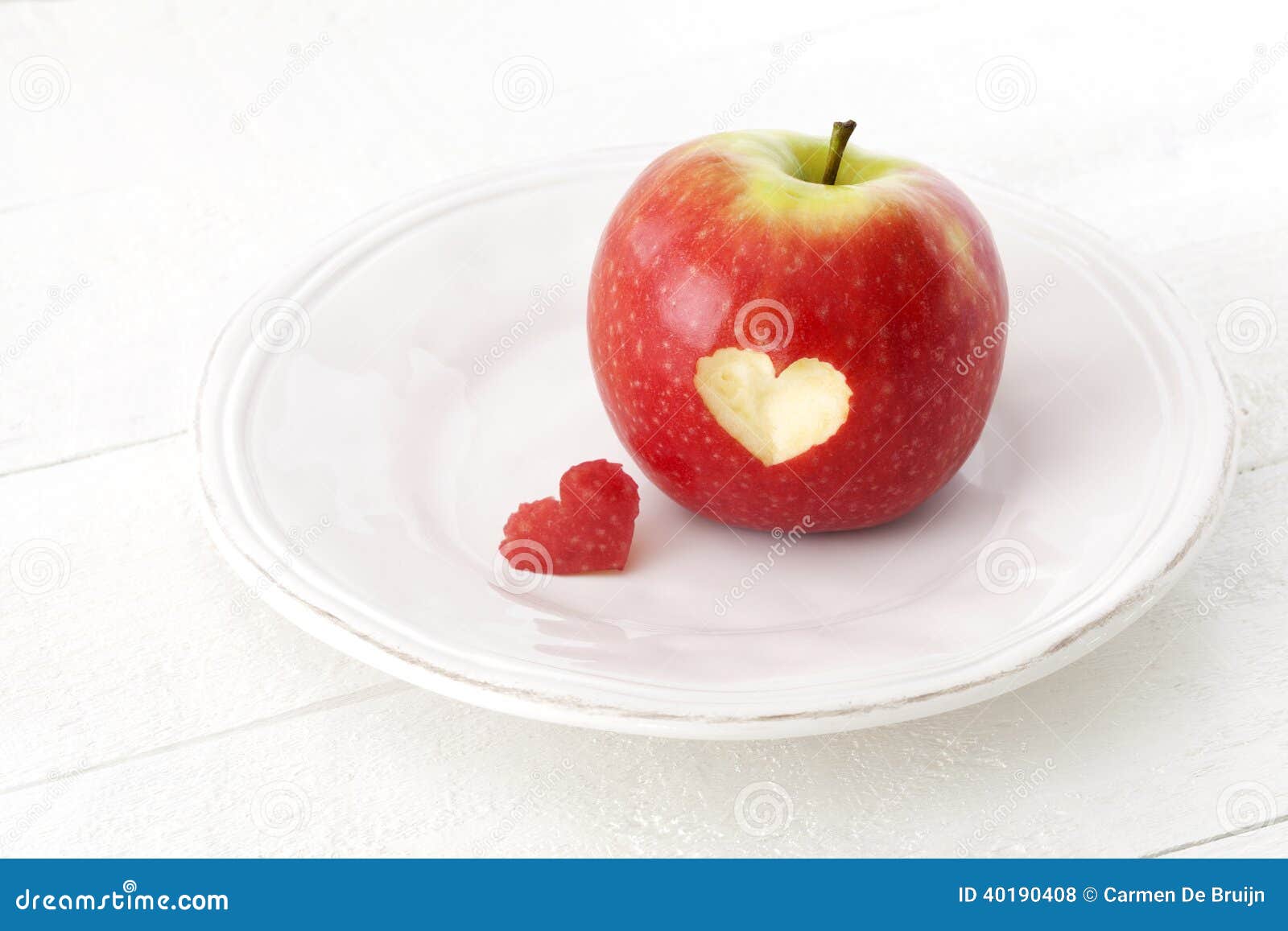 Apple with a Heart Shaped Cut-out on a Plate Stock Photo - Image of ...