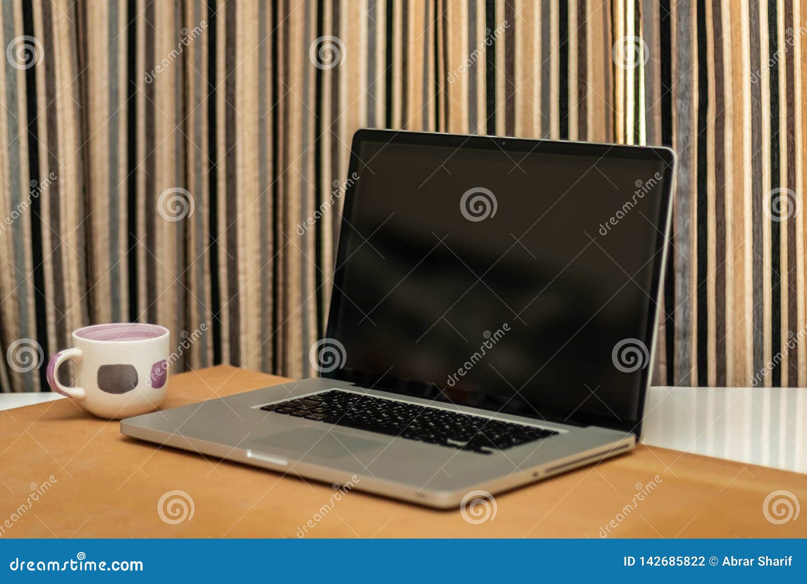 Laptop Computer on the Table in Office Along with a Coffee Cup ...