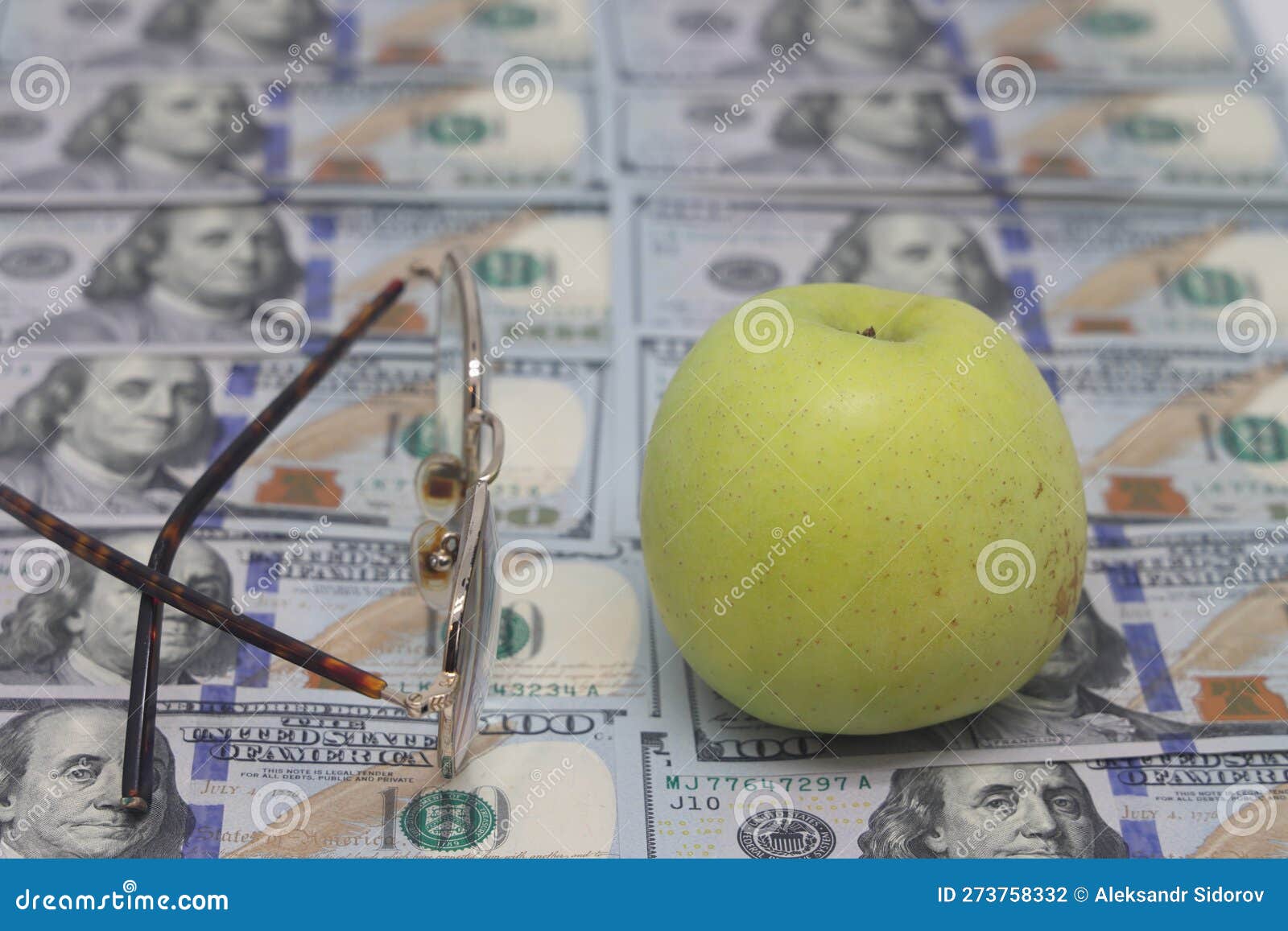 An Apple Lying on the Background of One Hundred Dollar Bills, Dollar ...