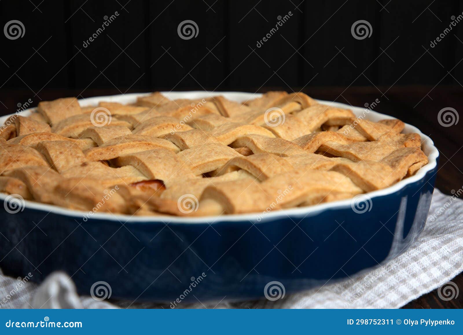 Apple Pie in Blue Form on a Dark Wooden Background with a Gray Kitchen ...