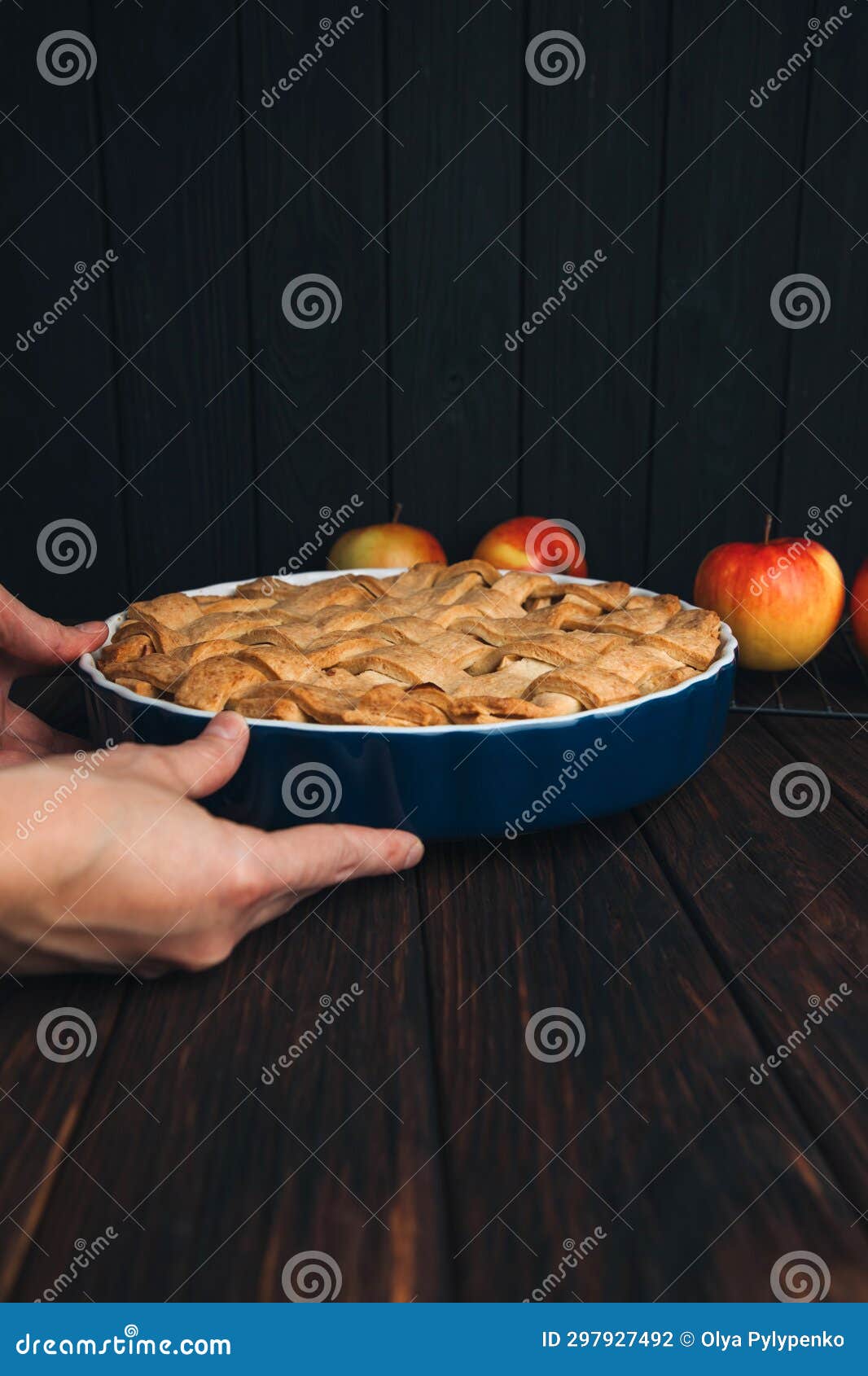 Apple Pie in Blue Form in Man& X27;s Hands on a Dark Wooden Background ...
