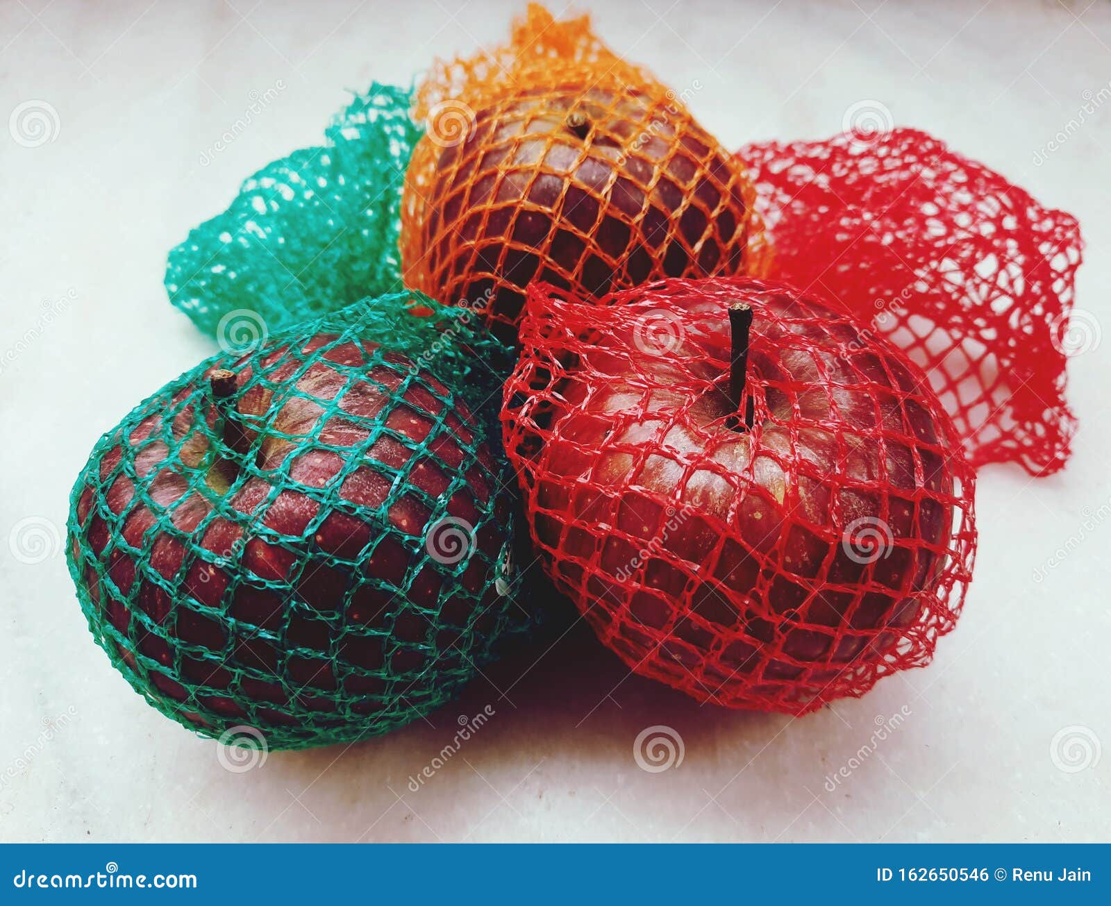 Apples covered in net stock photo. Image of background - 162650546