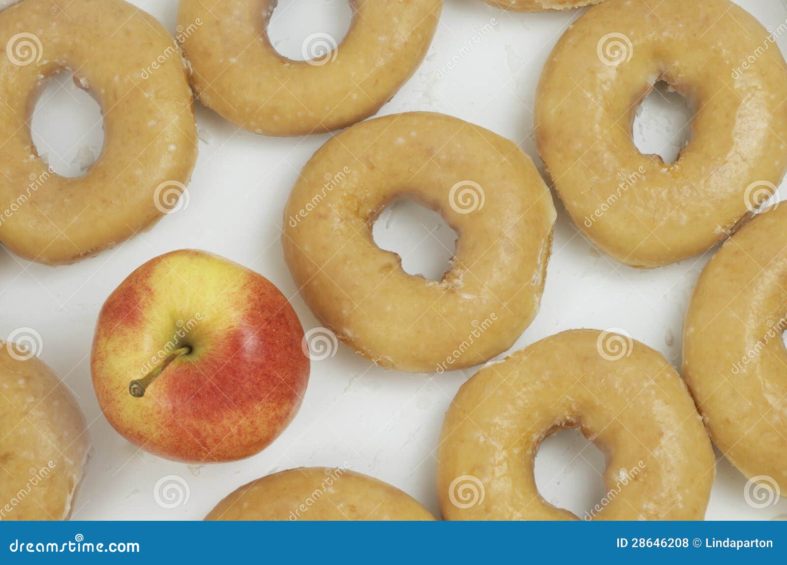 Apple Versus Donuts stock photo. Image of selection, opposites - 28646208