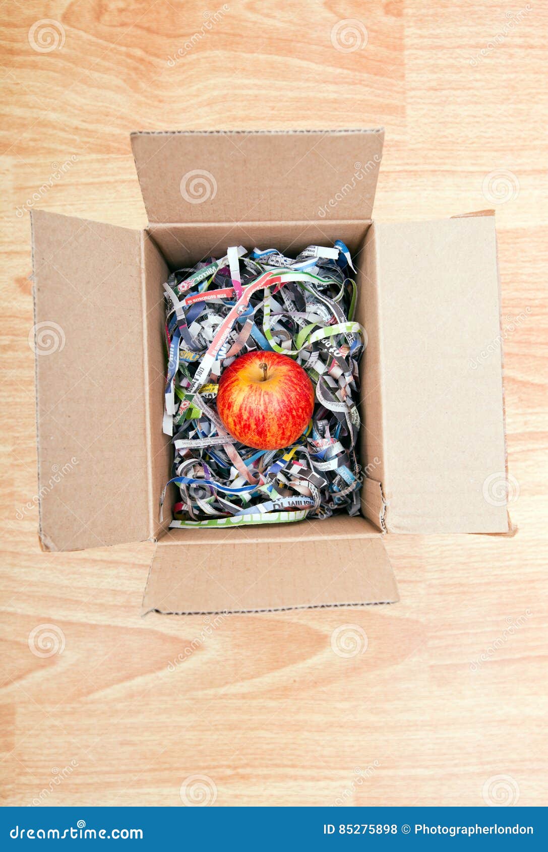 Apple wrapped up in a box editorial stock photo. Image of weight - 85275898