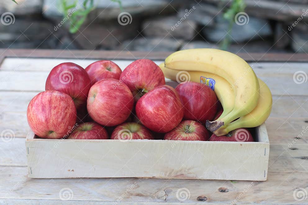 Apples and Bananas in a Box on a Table Stock Photo - Image of apple ...