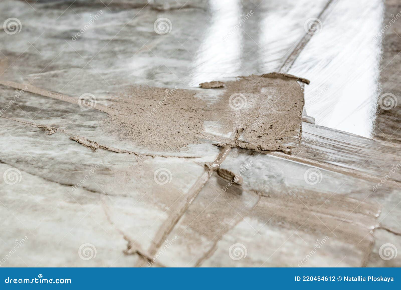 Applying a Beige Grout on the Floor Lined with Tiles. Stock Photo ...