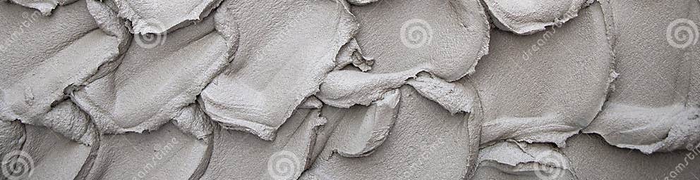 Applying Cement Plaster in a Thick Layer on a Concrete Wall by a ...