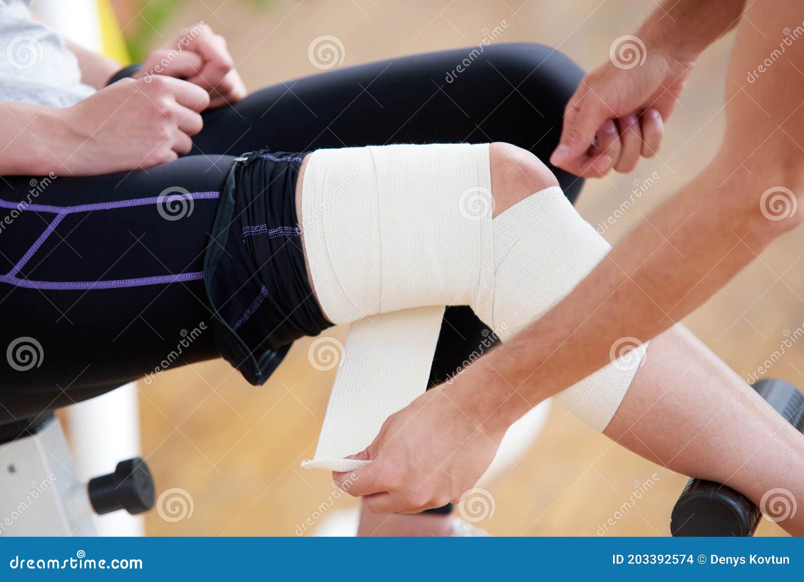 Applying a Compression Wrap for a Sprained Muscle. Stock Photo - Image ...