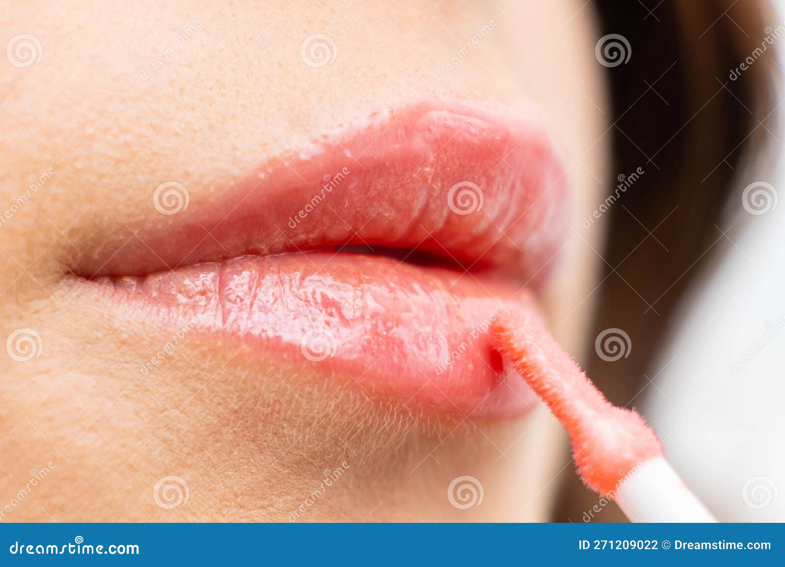 Applying Lip Gloss on the Beautiful Full Lips Stock Photo - Image of ...