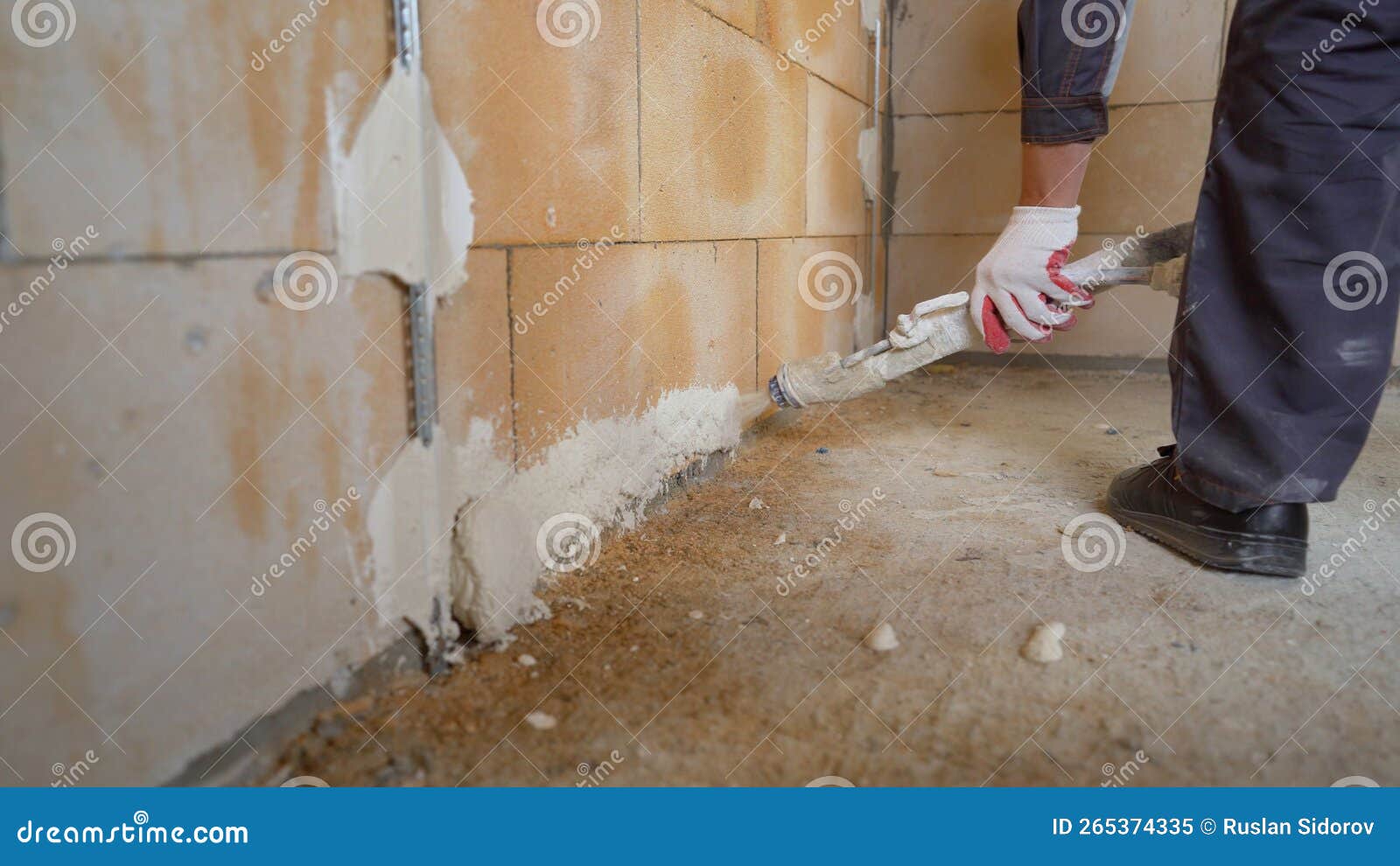 A Worker Sprays Putty on a Wall. the Process of Applying Plaster To ...