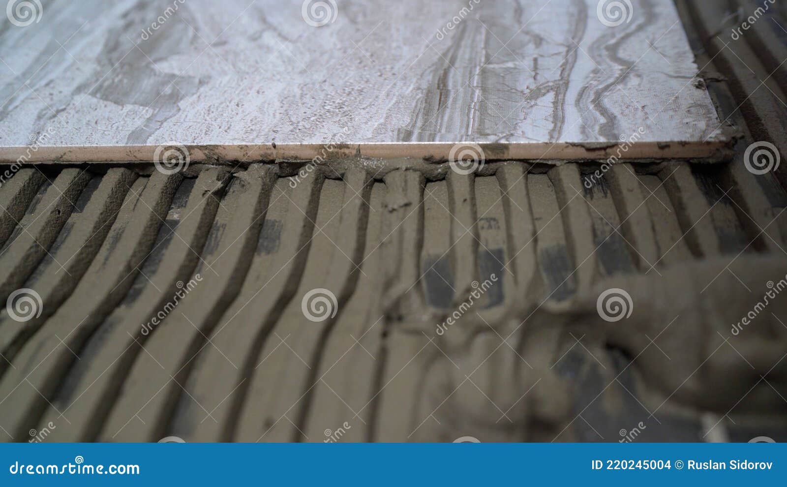 The Process of Laying Ceramic Floor Tiles. Spreading Wet Mortar before ...