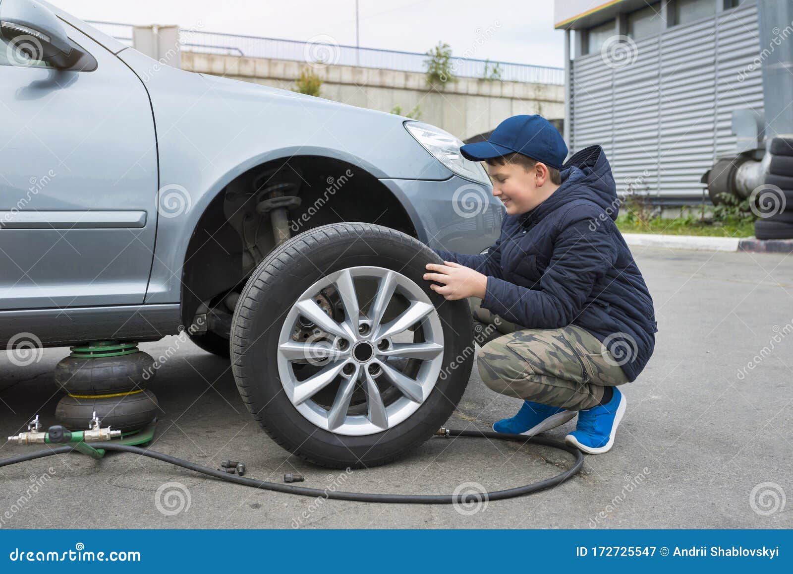 Apprentice Auto Mechanic Changes the Wheel of a Car. Auto Repair ...