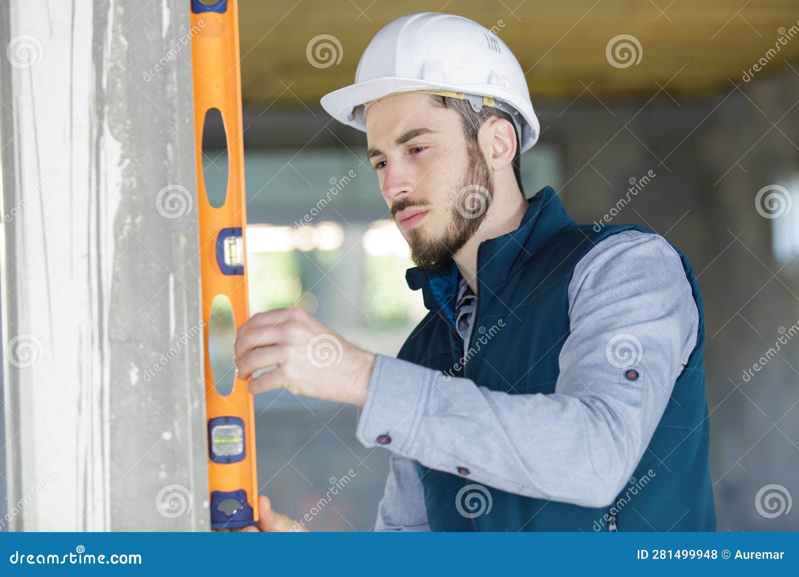 Apprentice Builder Using Spirit Level Stock Photo - Image of person ...