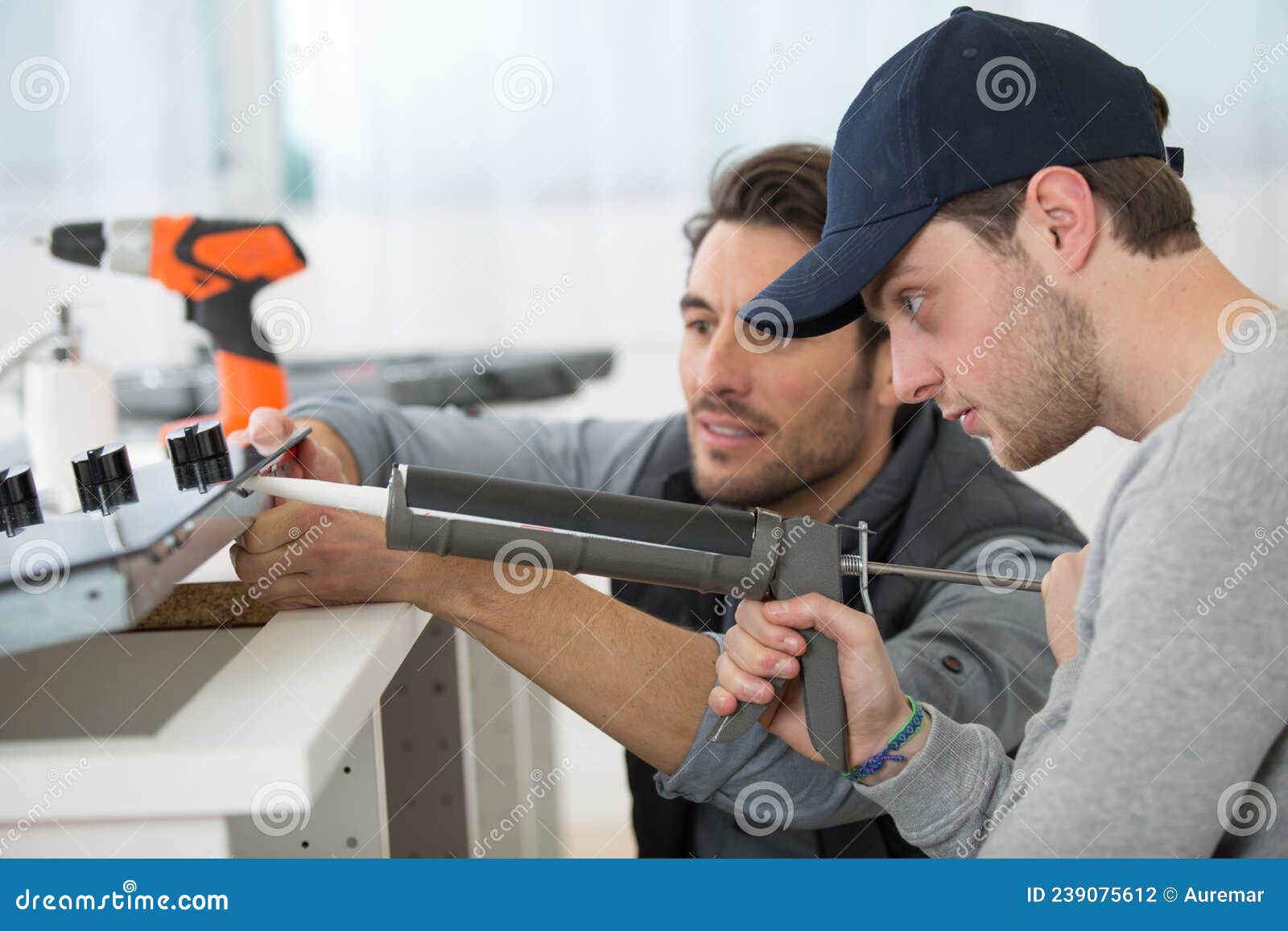 Apprentice and Carpenter Insert Sink into Kitchen Counter Stock Photo ...