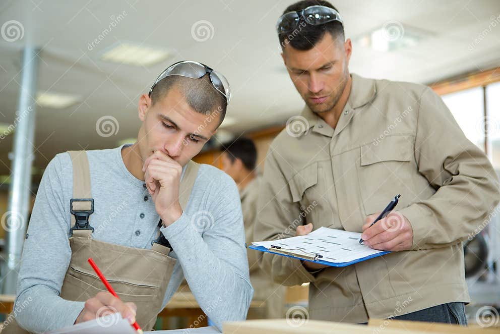 Apprentice Carpenter Taking Notes with Tutor Stock Image - Image of ...