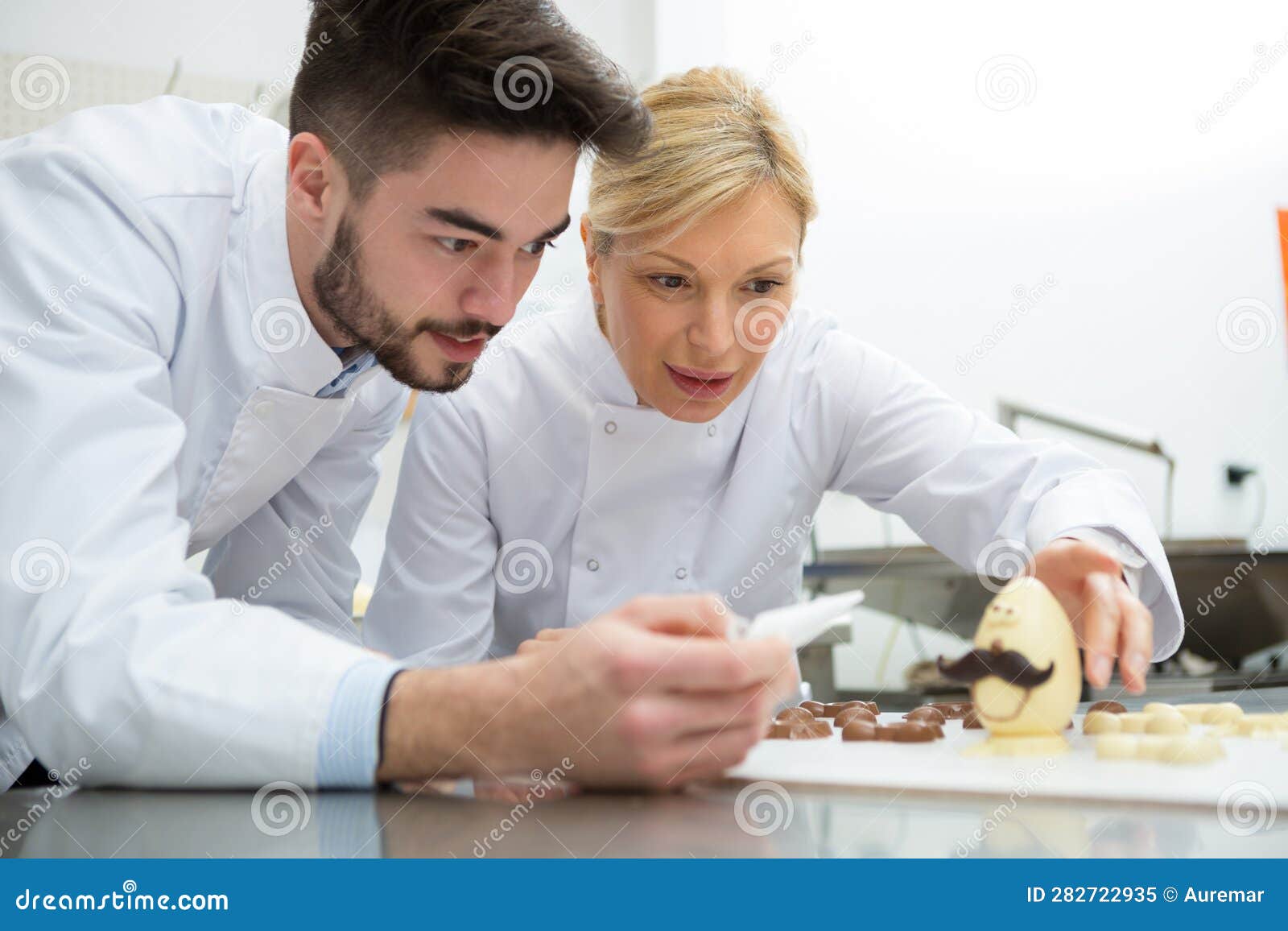 Apprentice and Confectioner Working in Chocolate Factory Stock Image ...
