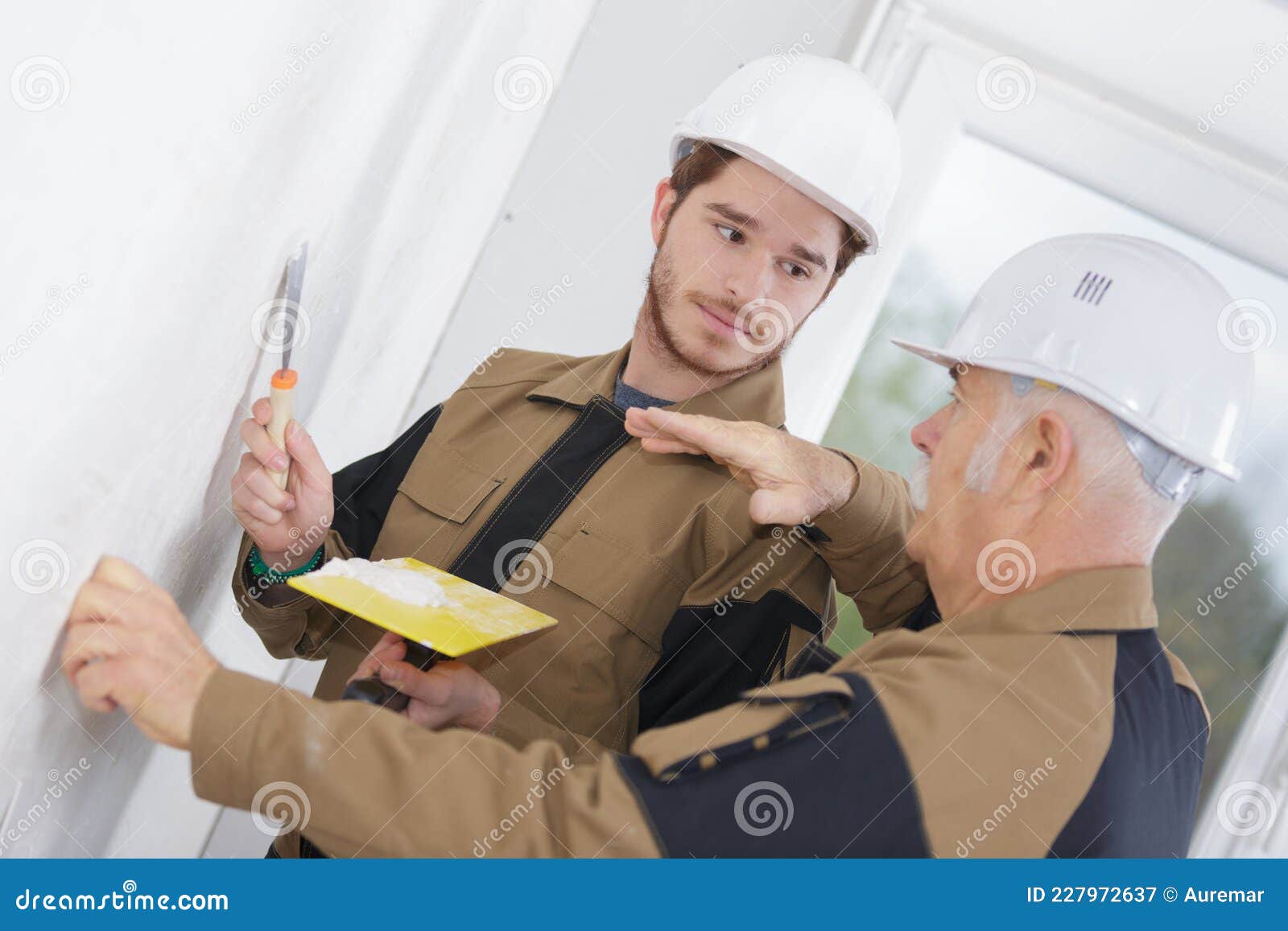 Apprentice Construction Worker with Trowel Plastering Wall Stock Image ...