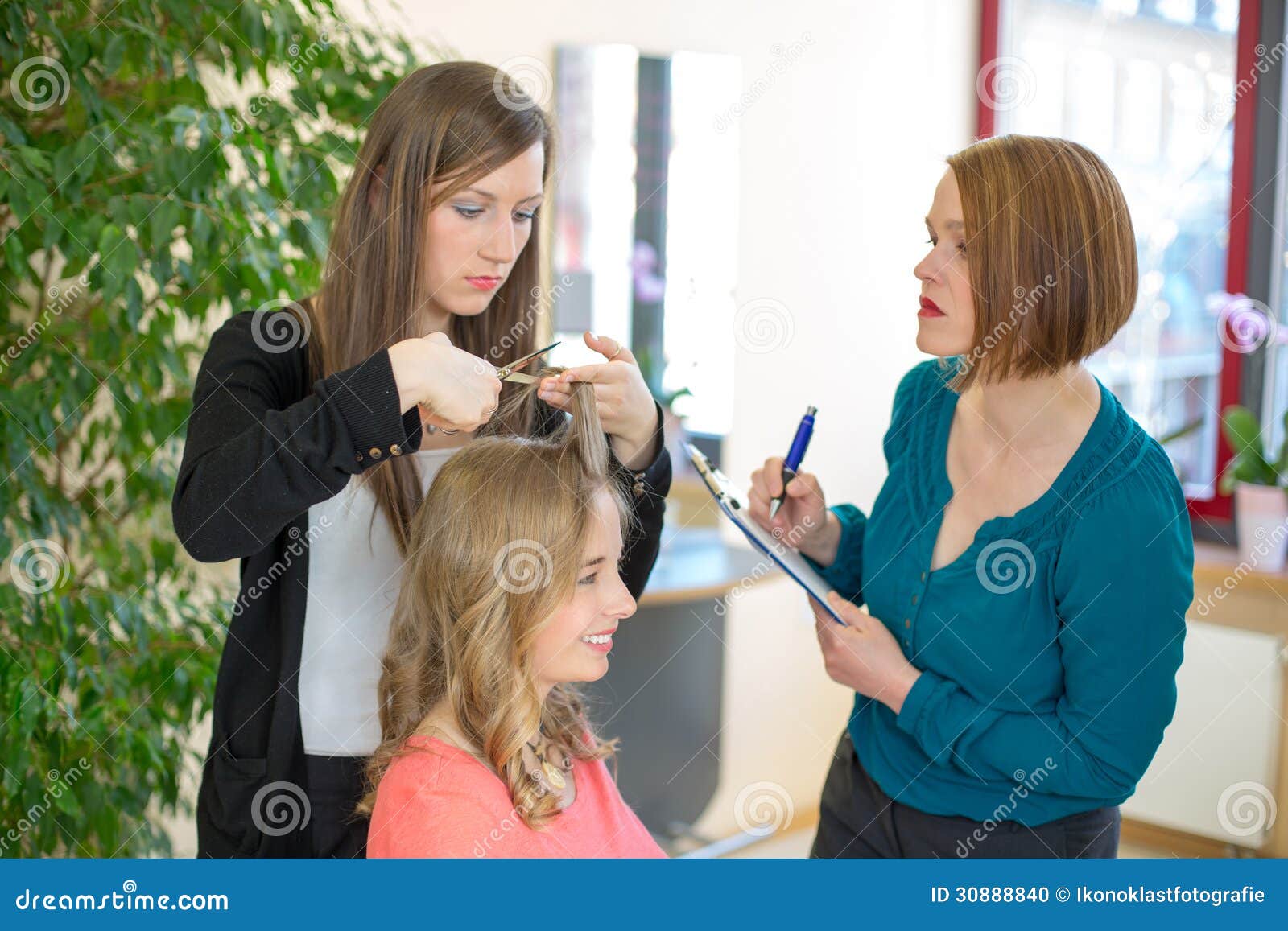 Apprentice Cutting Hair while Instructor is Watching Stock Photo ...