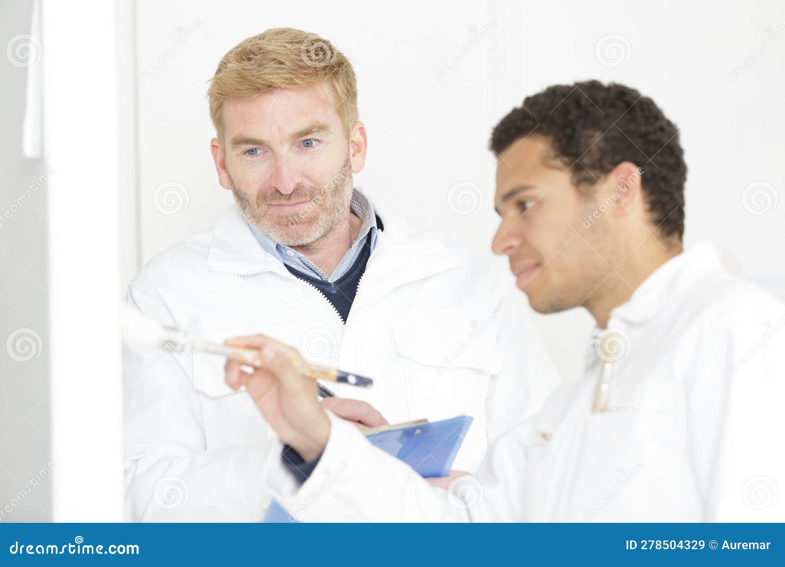 Apprentice Decorator Working Under Supervision Stock Image - Image of ...