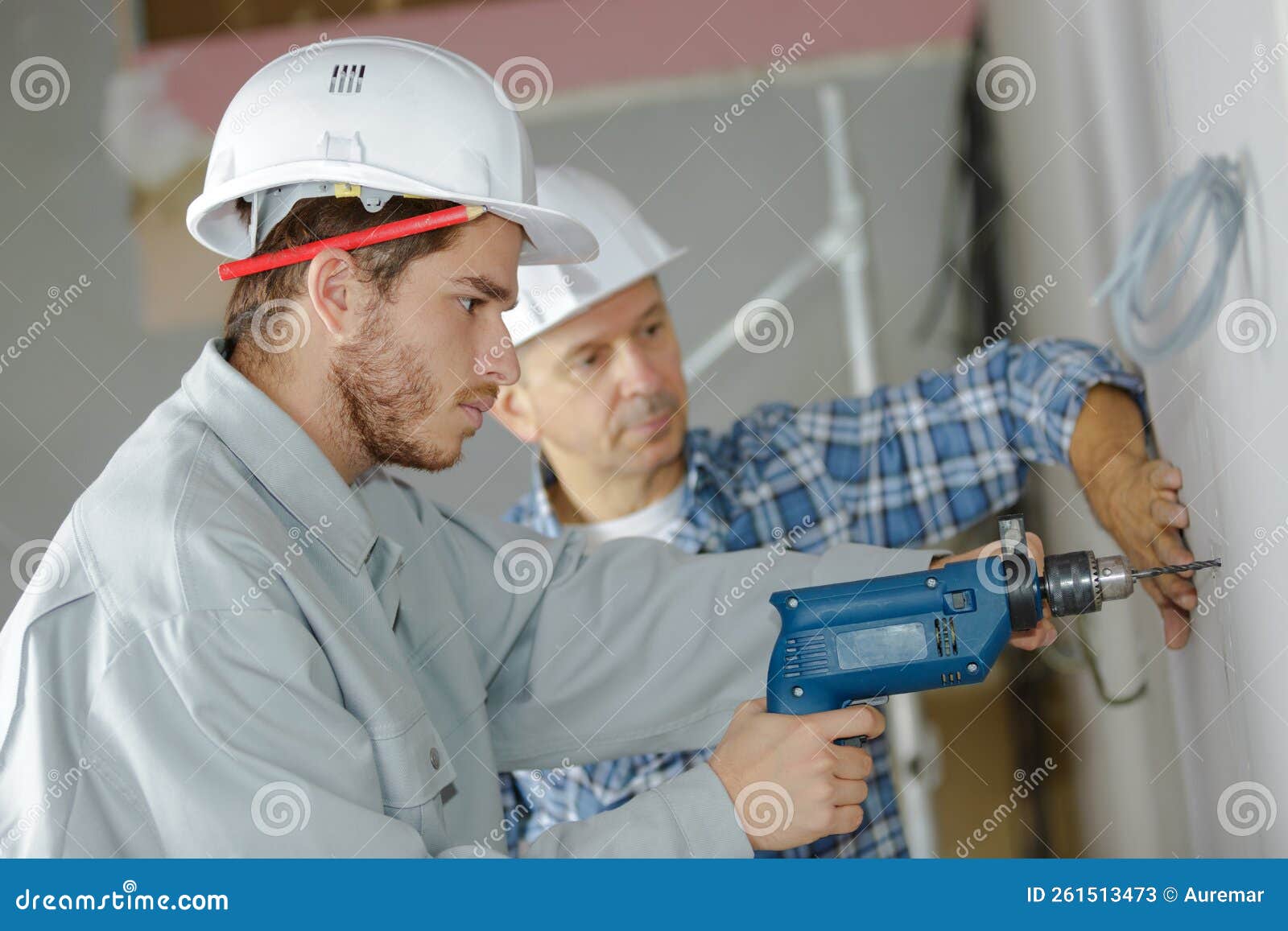 Apprentice Drilling Holes at Construction Site Stock Image - Image of ...