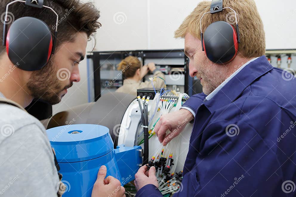 Apprentice Engineer Being Shown Cable Connections Stock Image - Image ...