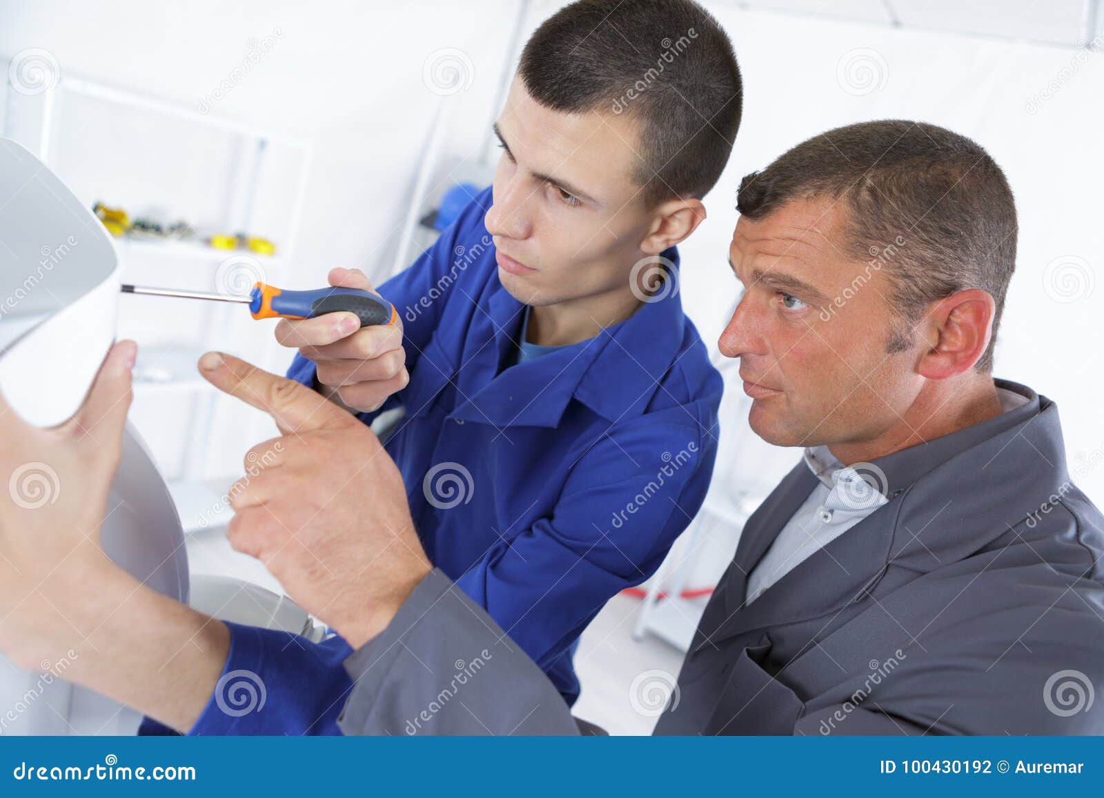 Apprentice Fixing Something with Help Teacher Stock Photo - Image of ...