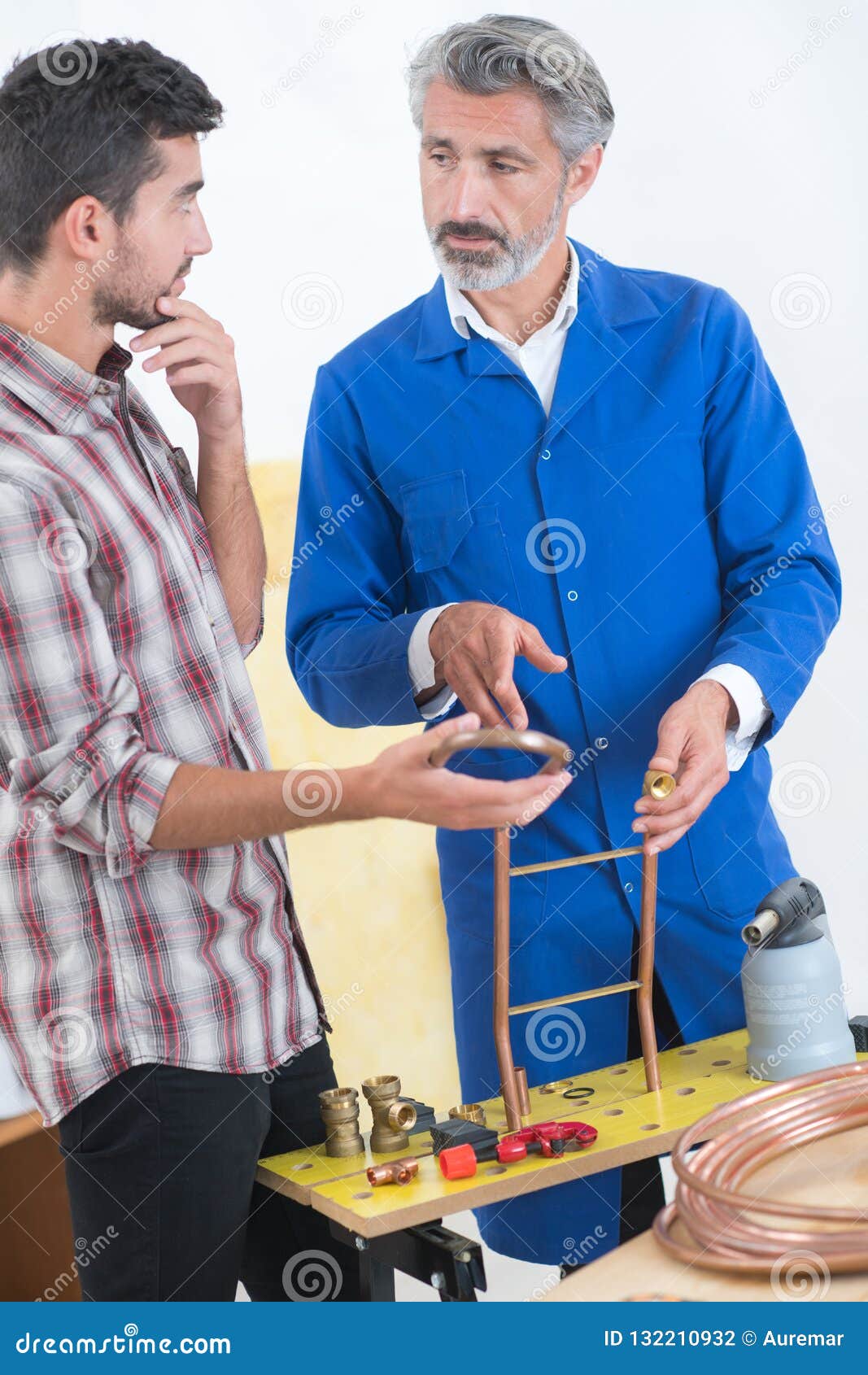 Apprentice Learning about Copper Pipe Fittings with Instructor Stock ...