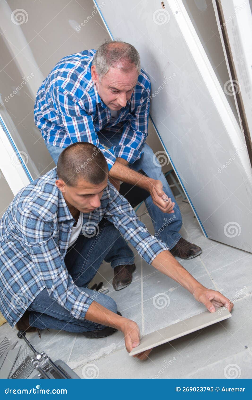 Apprentice Learning To Fit Tiles Stock Image - Image of glove ...