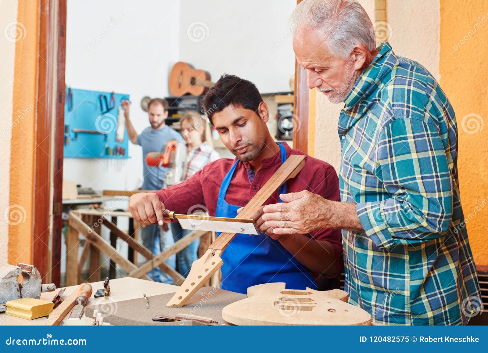 Apprentice of Luthier Learns with Master Stock Image - Image of blue ...
