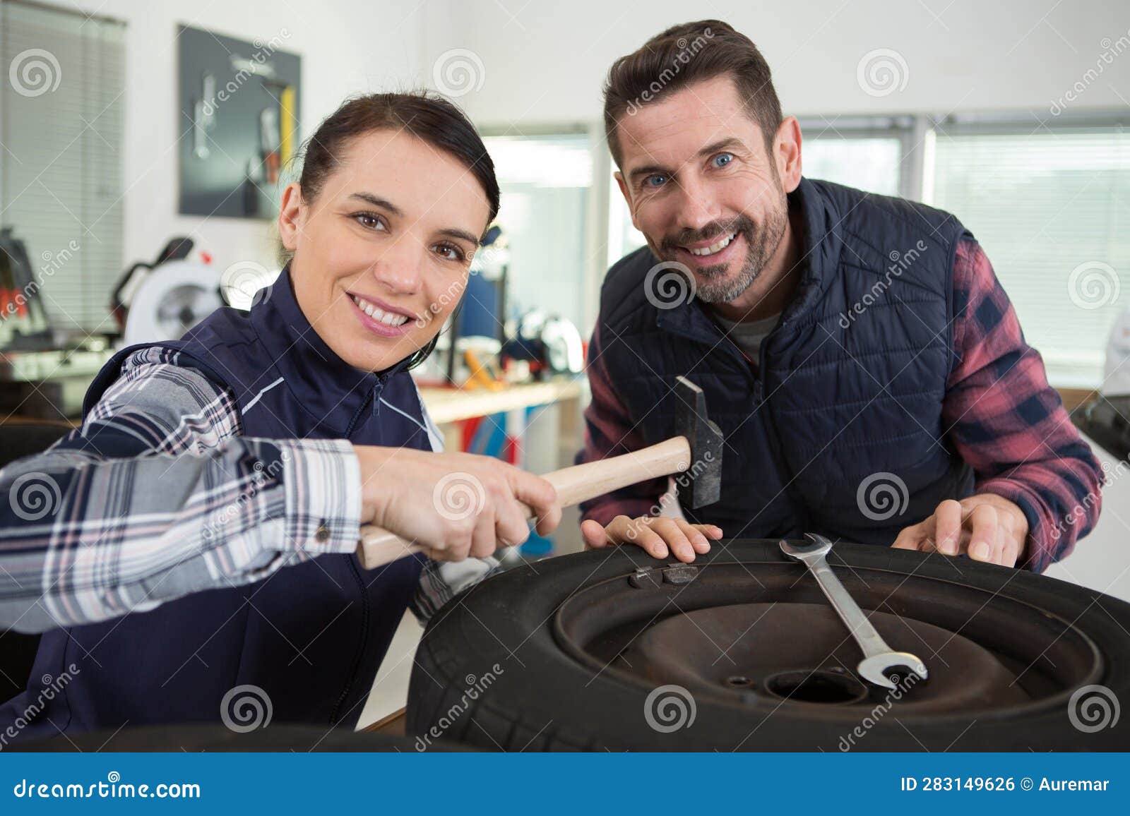 Apprentice Mechanic Working on Car Wheel Stock Photo - Image of ...