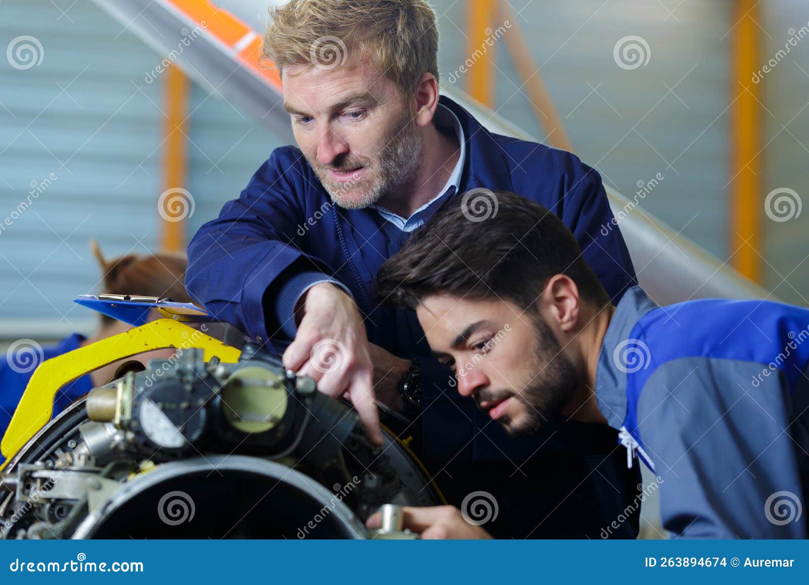 Apprentice Mechanic Working Under Supervision Stock Photo - Image of ...