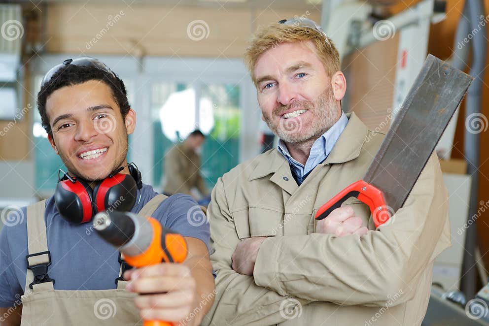 Apprentice and Mentor Looking at Camera in Carpentry Workshop Stock ...