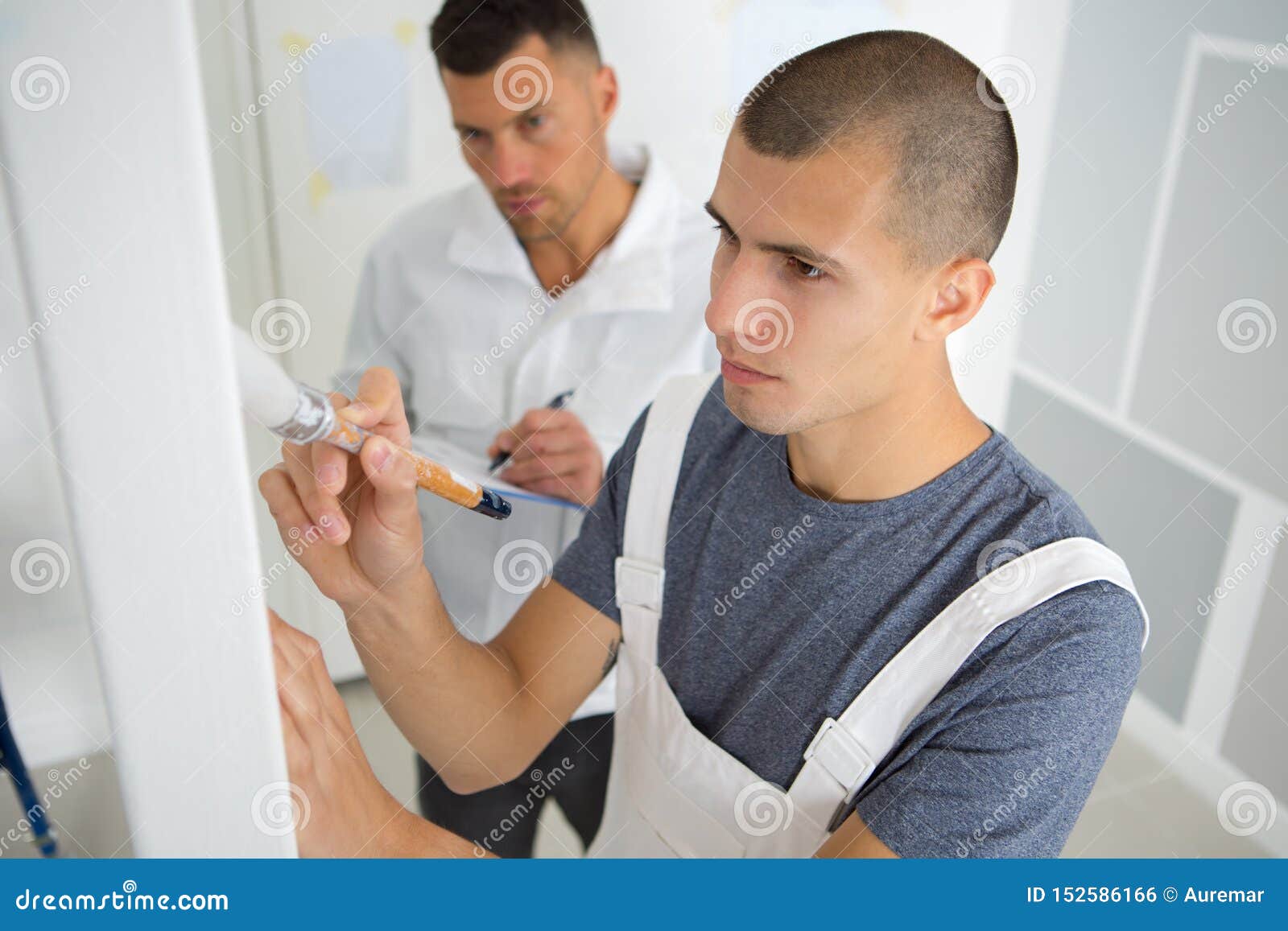 Apprentice Painter Working Under Supervision Stock Photo - Image of ...