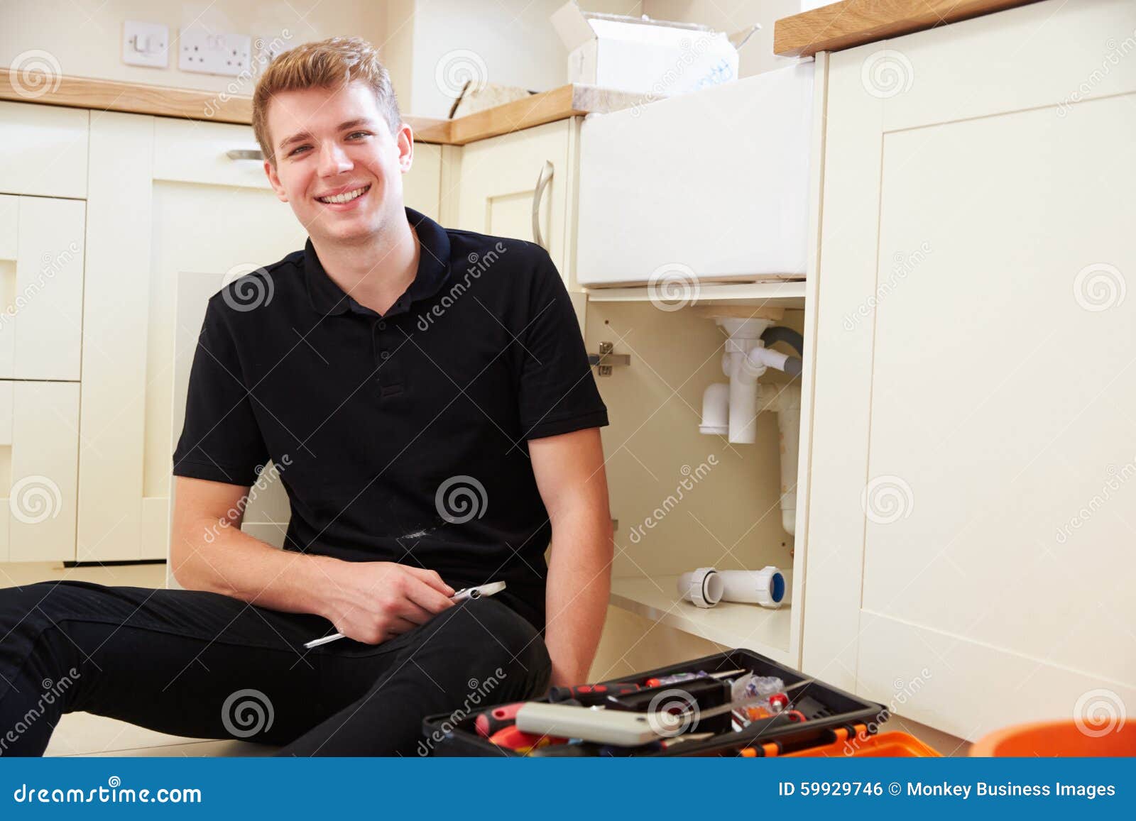 Apprentice Plumber Sitting in a Kitchen, Portrait Stock Photo - Image ...